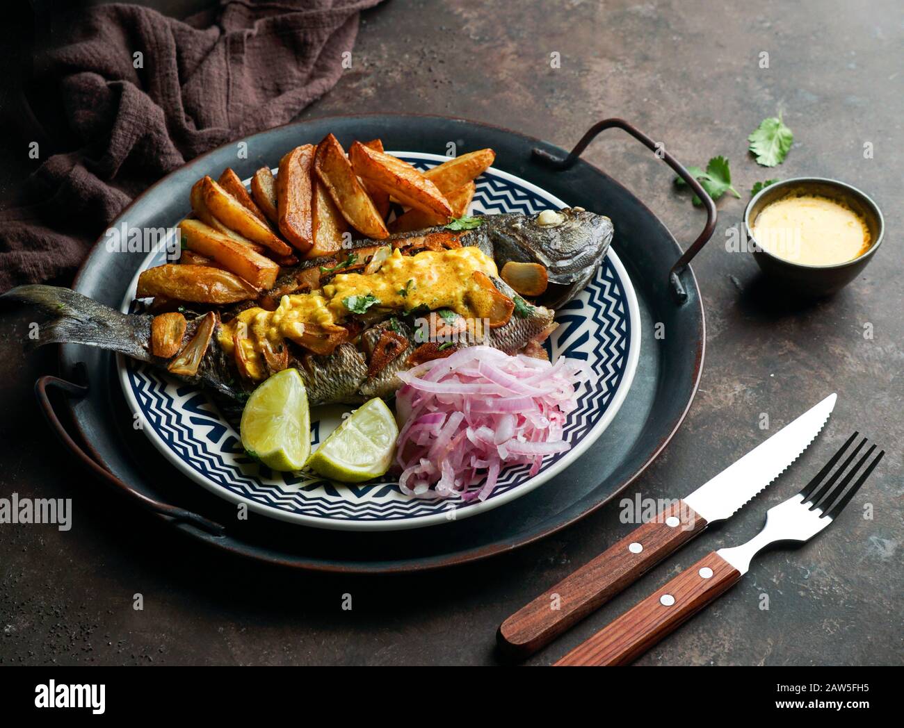 Chita frita al ajo, al ajillo, Peruvian food, a whole fish, served wit ...