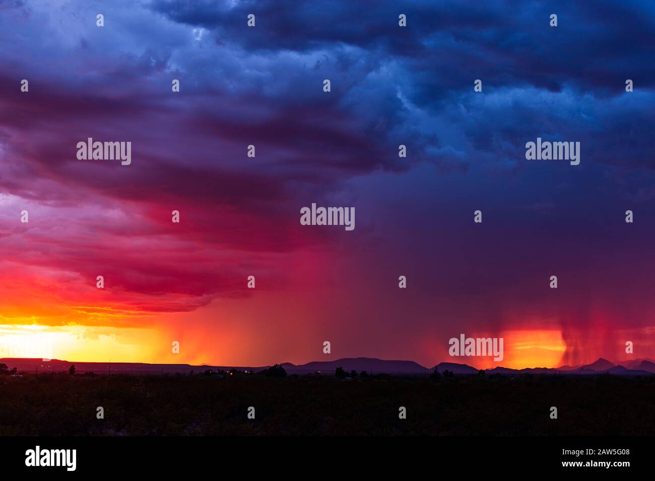 A dramatic, colorful sunset sky with monsoon thunderstorm clouds over ...