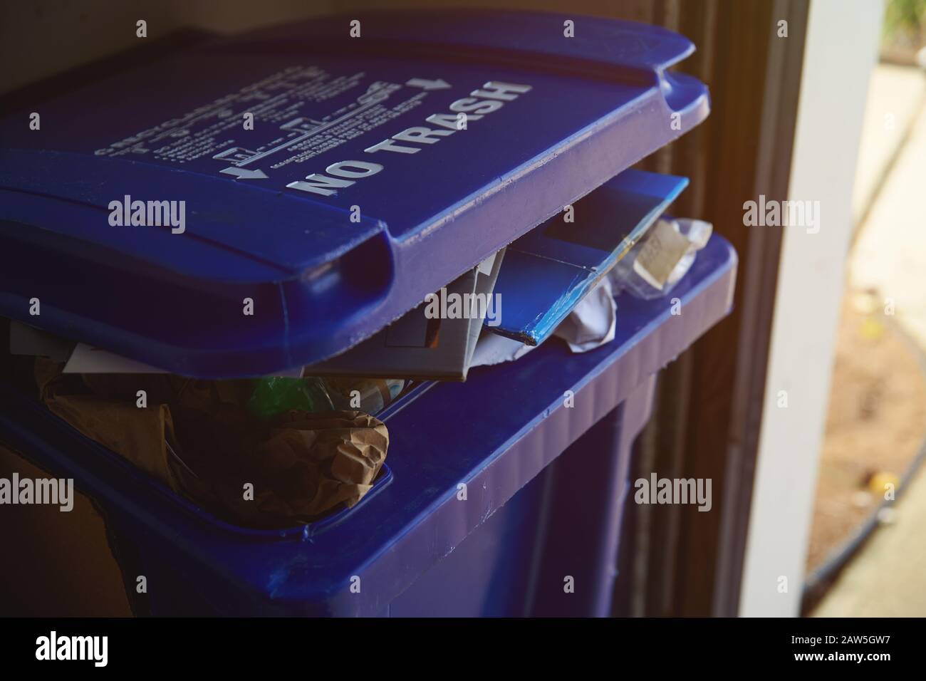 Recycling bin full of garbage Stock Photo - Alamy