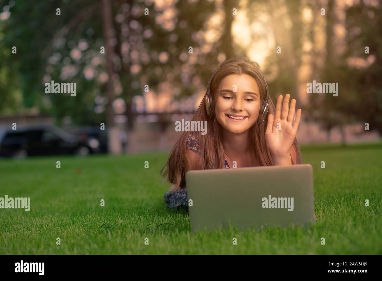 Hi there. Happy young cute student woman with smartphone headset on ...