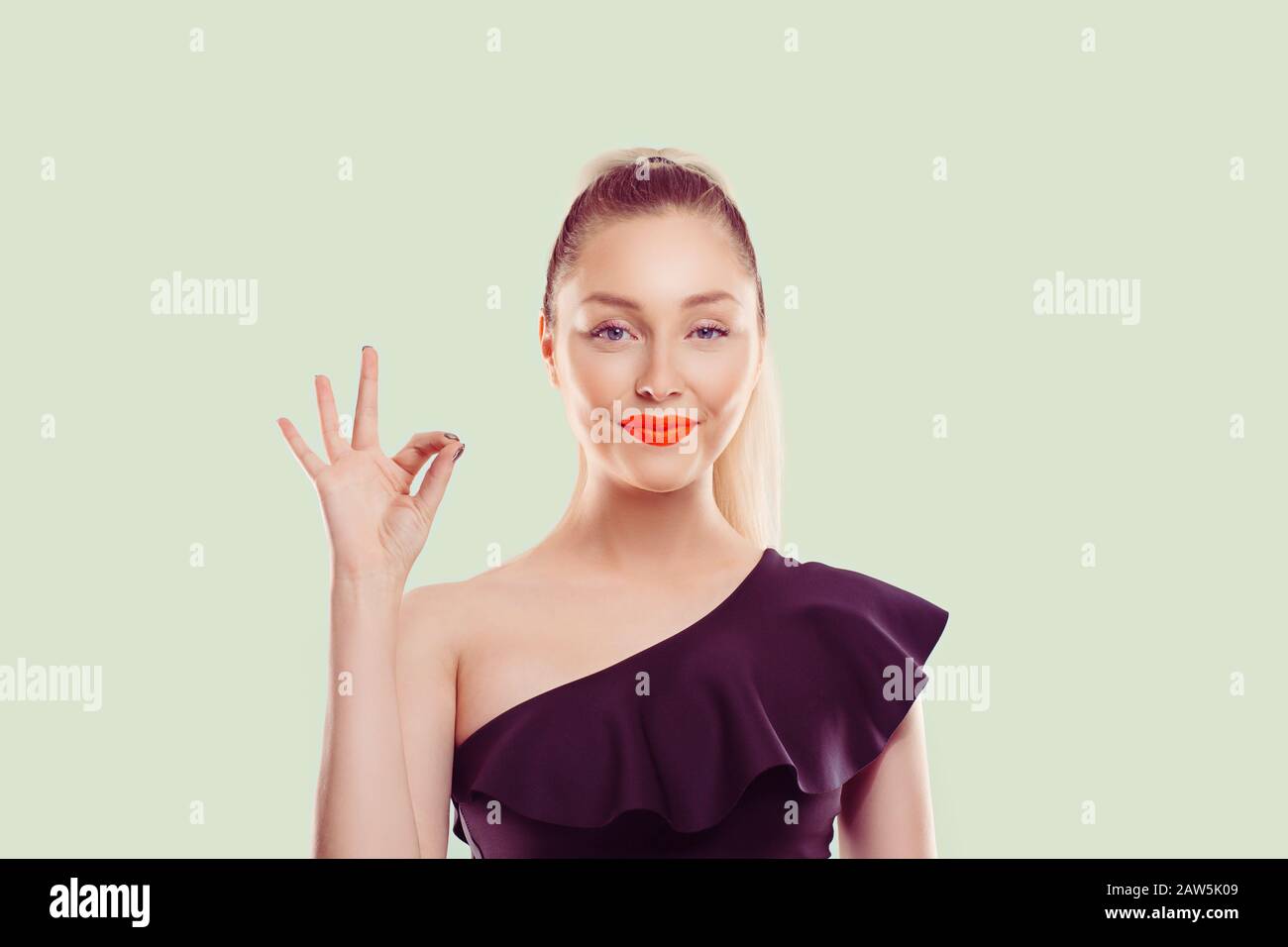 Everything will be alright. Beautiful young happy woman showing Ok sign ...