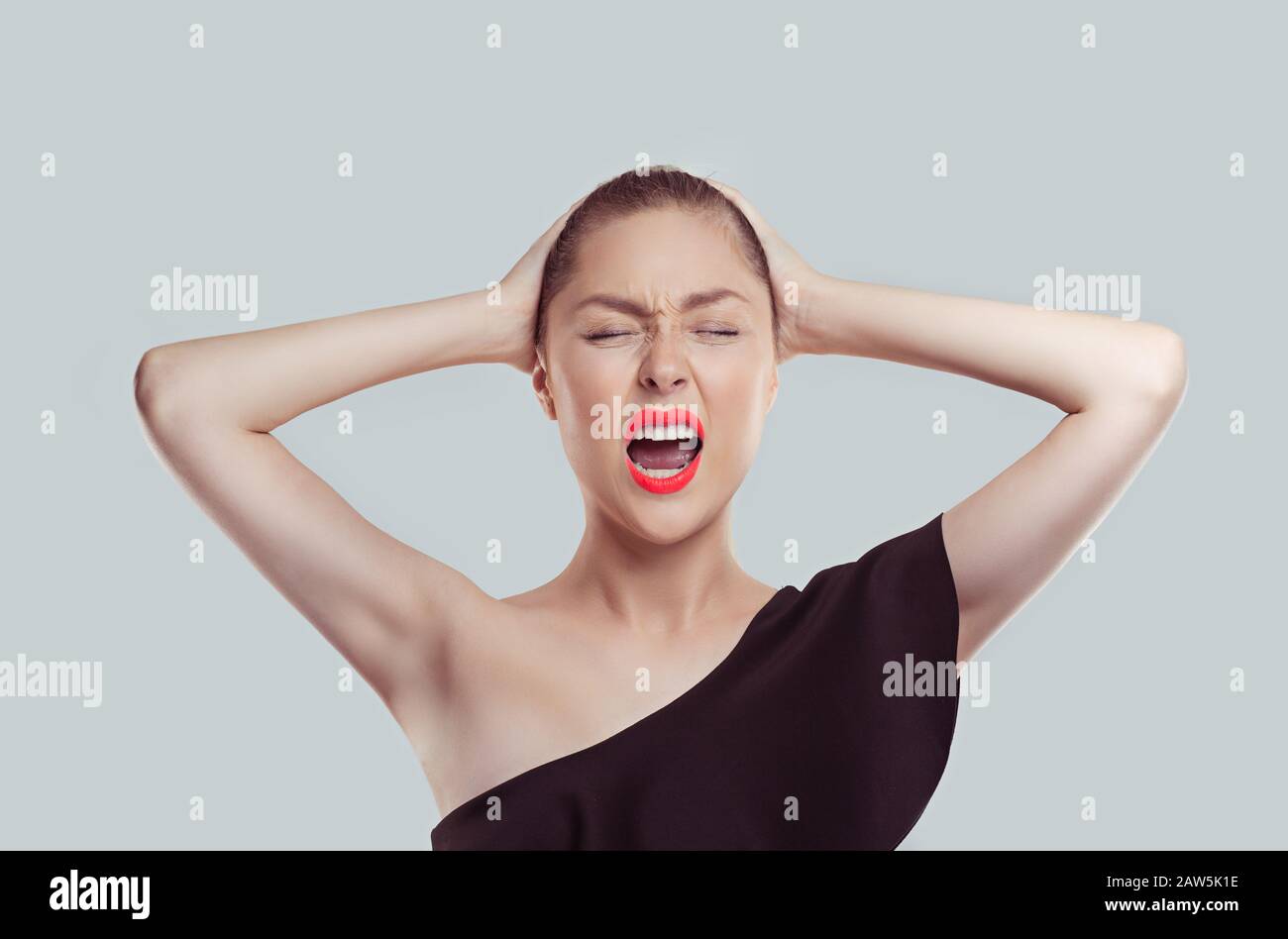 Portrait of stressed out young woman isolated on light blue gray wall ...