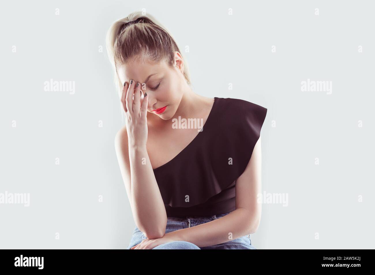 Depressed. Half length portrait sad young beautiful woman sitting with ...