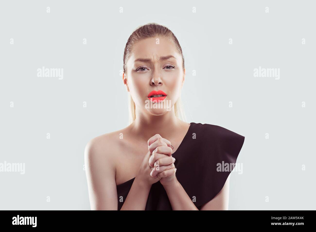 Please, I am begging you. Woman looking at you camera praying imploring ...