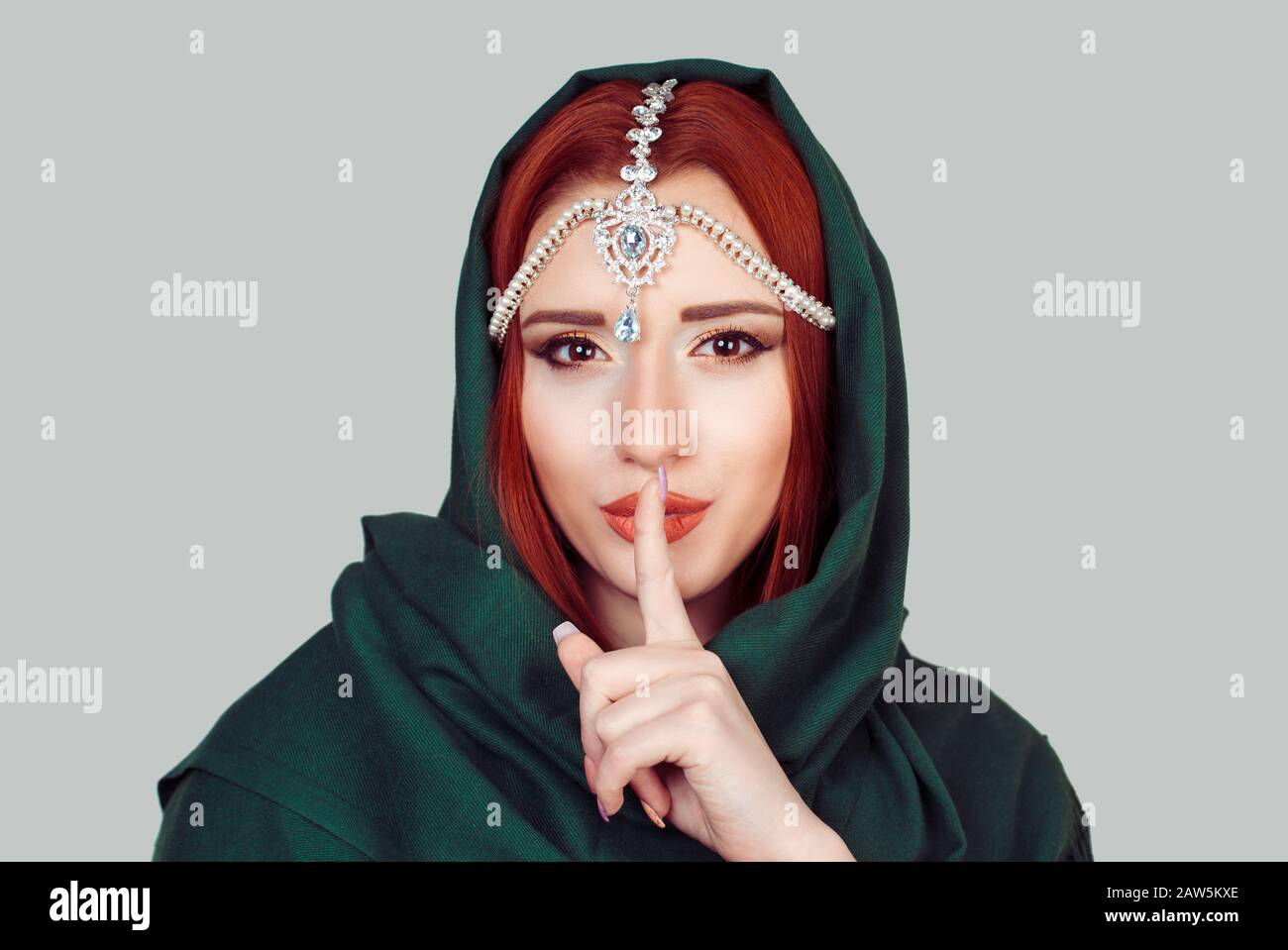 Shh. Pretty woman showing shh, hush, silence gesture with hand on light ...