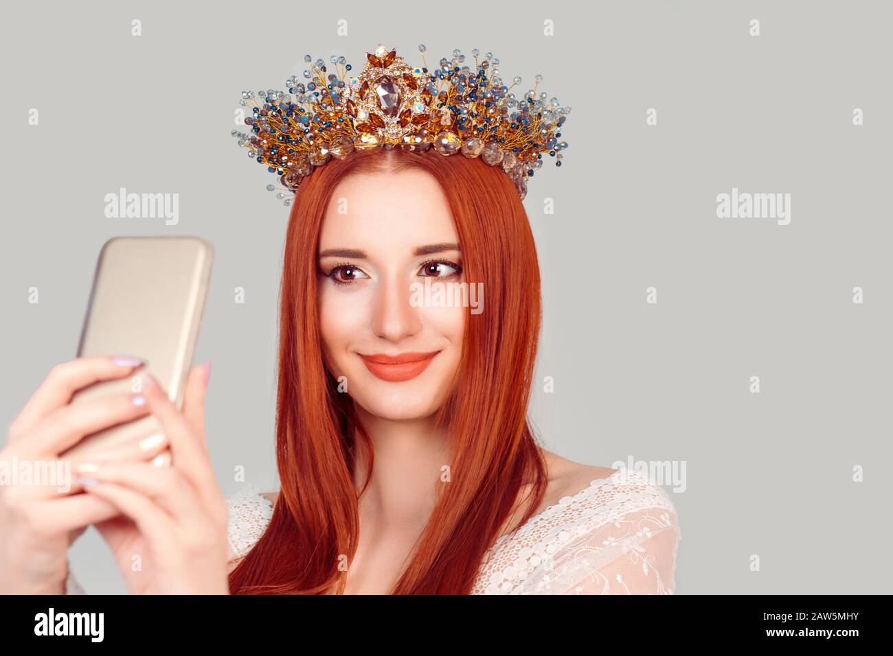 Self portrait. Young beauty queen in white lace dress making selfie ...