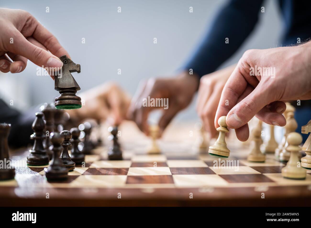 Business People Making Moves At The Same Time Stock Photo - Alamy