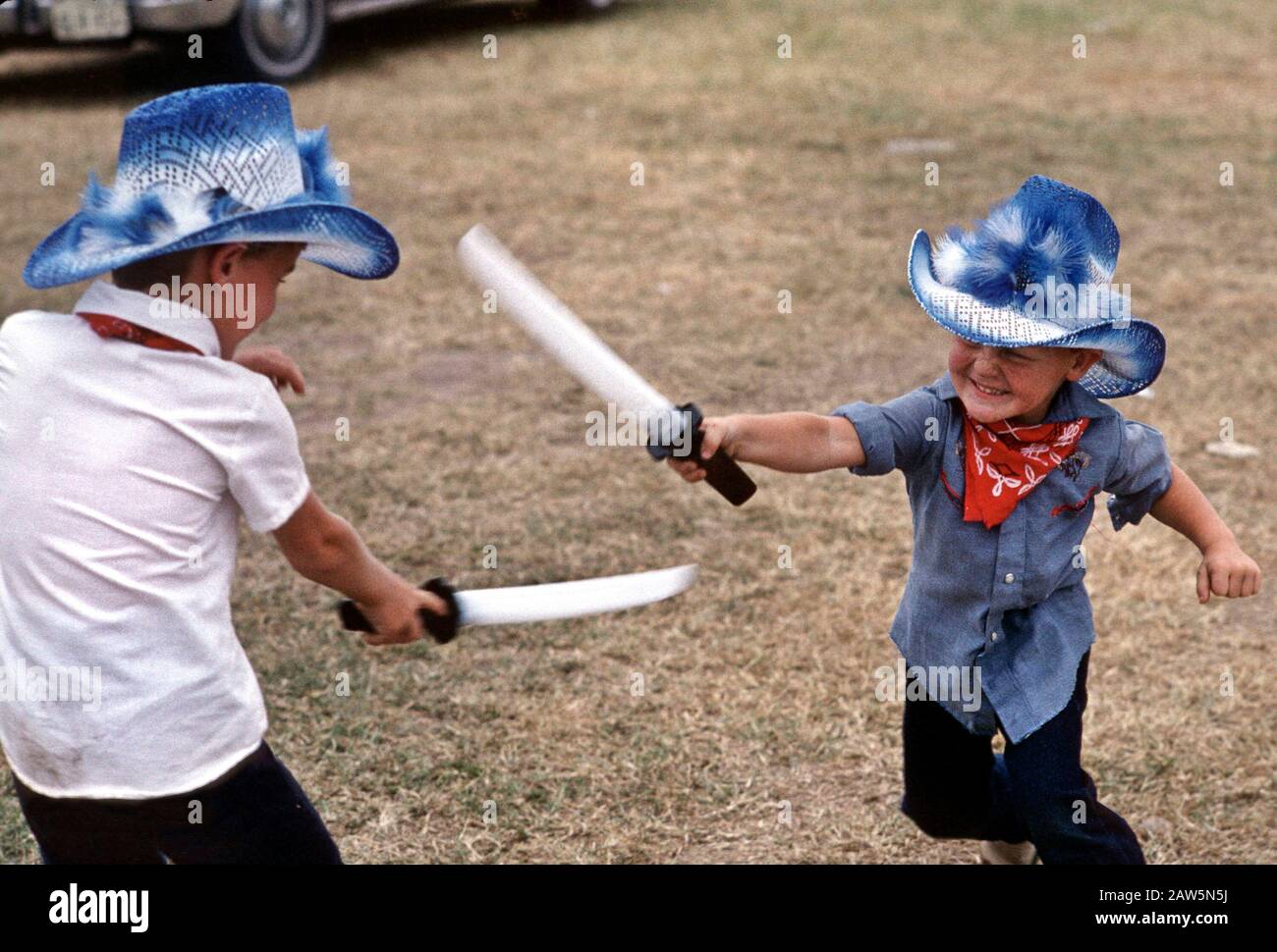 Children playing with toy swords. ©Bob Daemmrich Stock Photo - Alamy