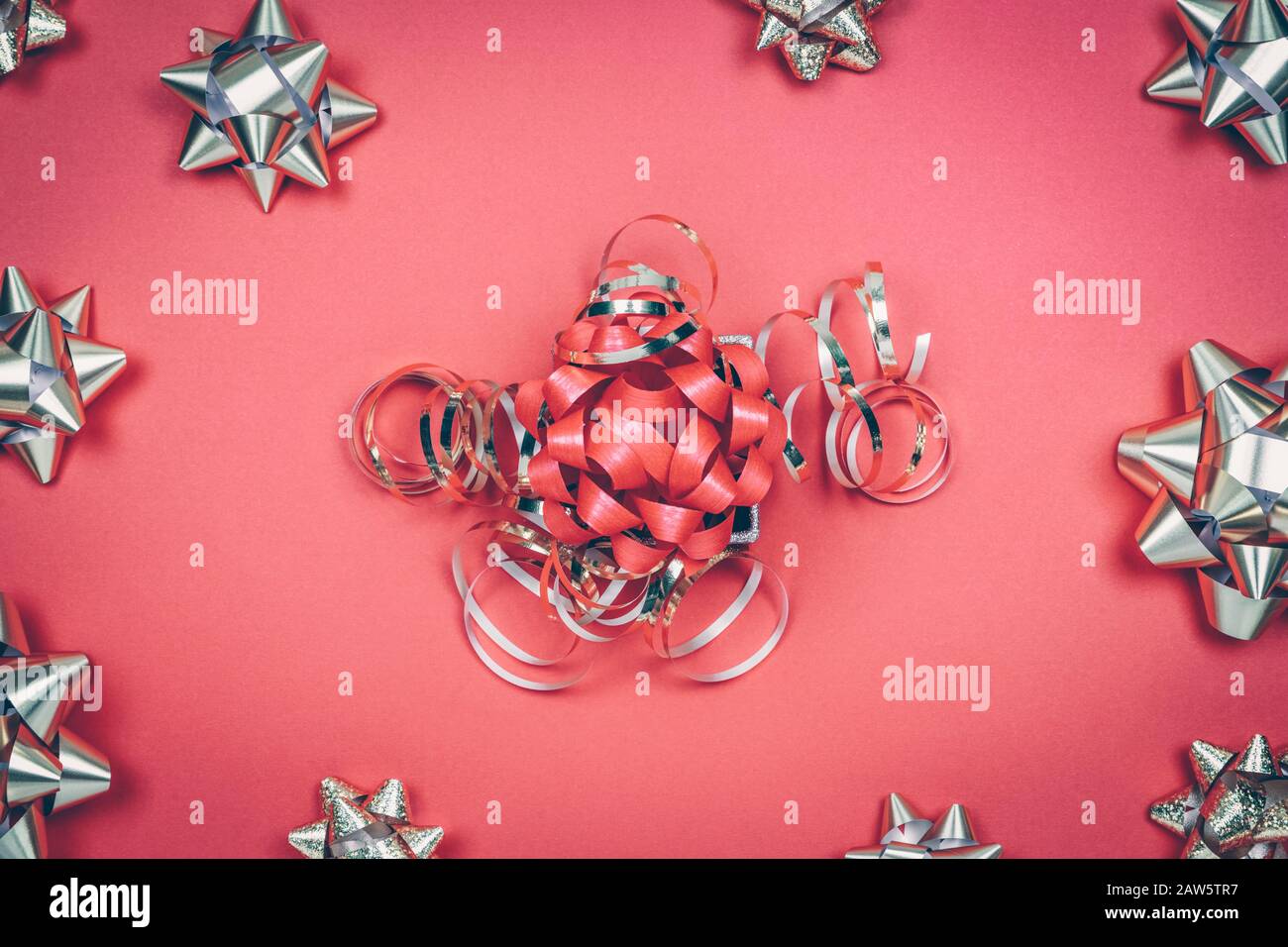 Gift box with recycled materials bow and silver gift bows on the red ...