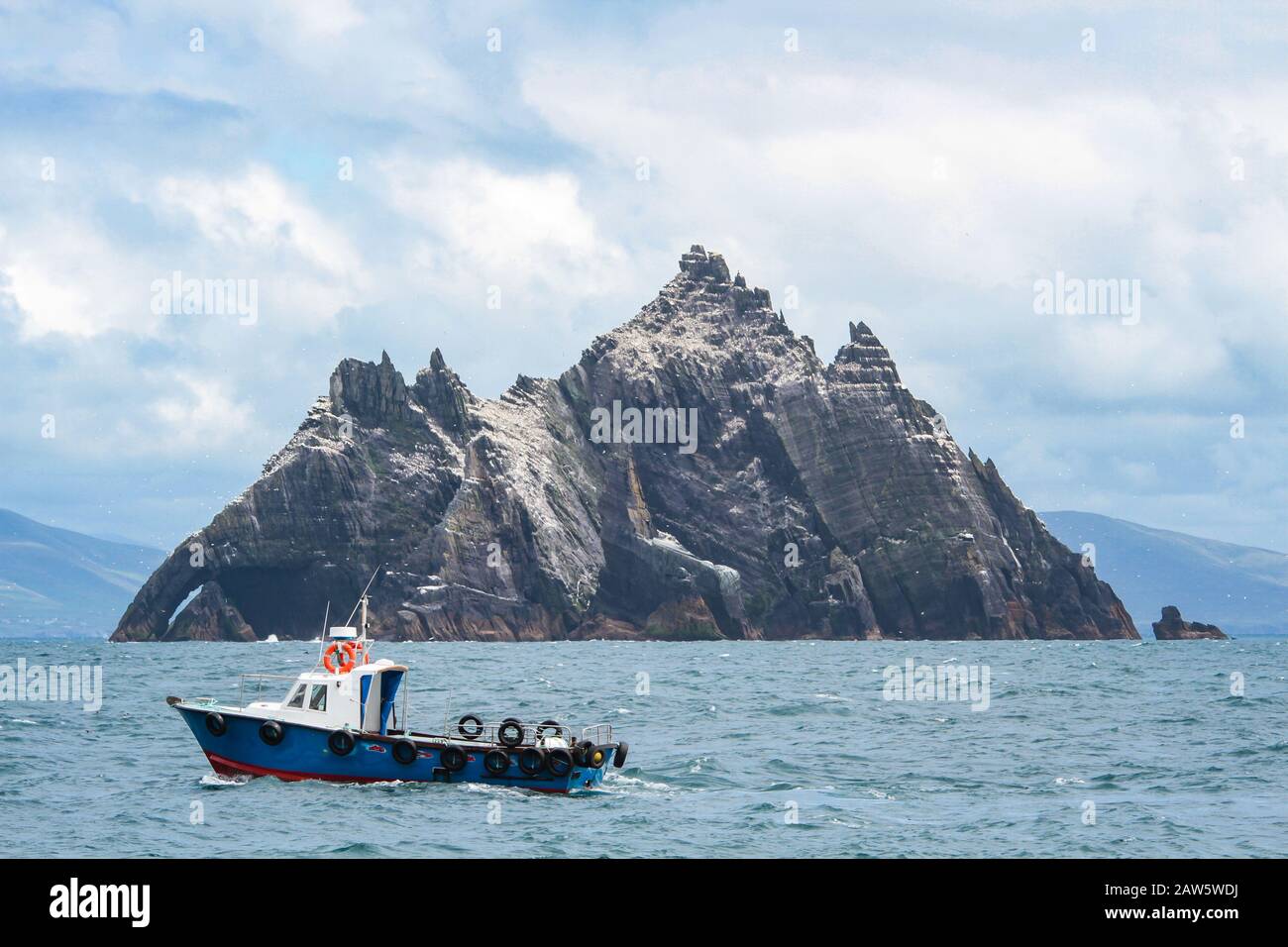 Excursion boat drives past Little Skellig, island in the Atlantic Ocean ...