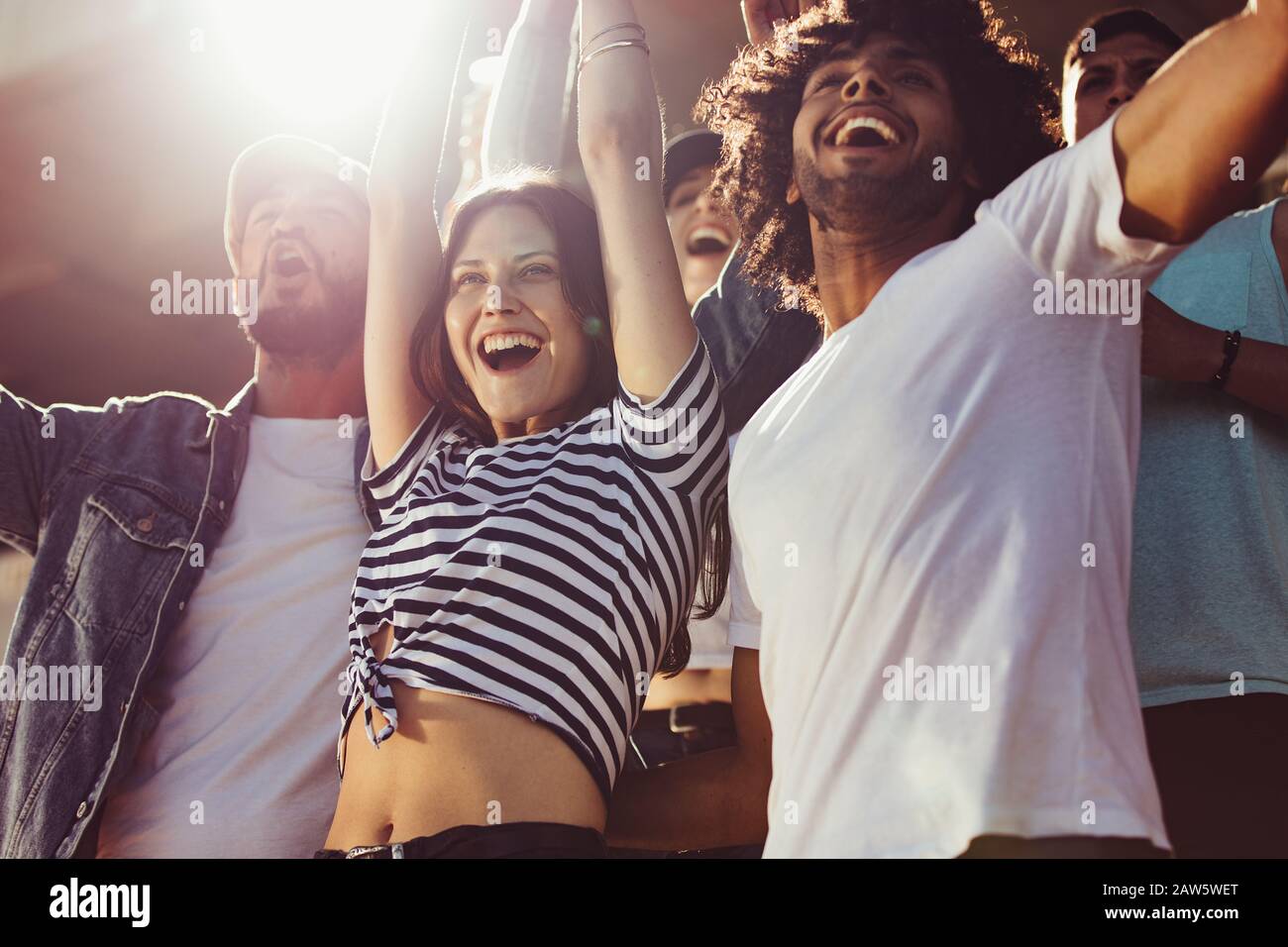 Group of soccer fans in stadium yelling and cheering for their team ...
