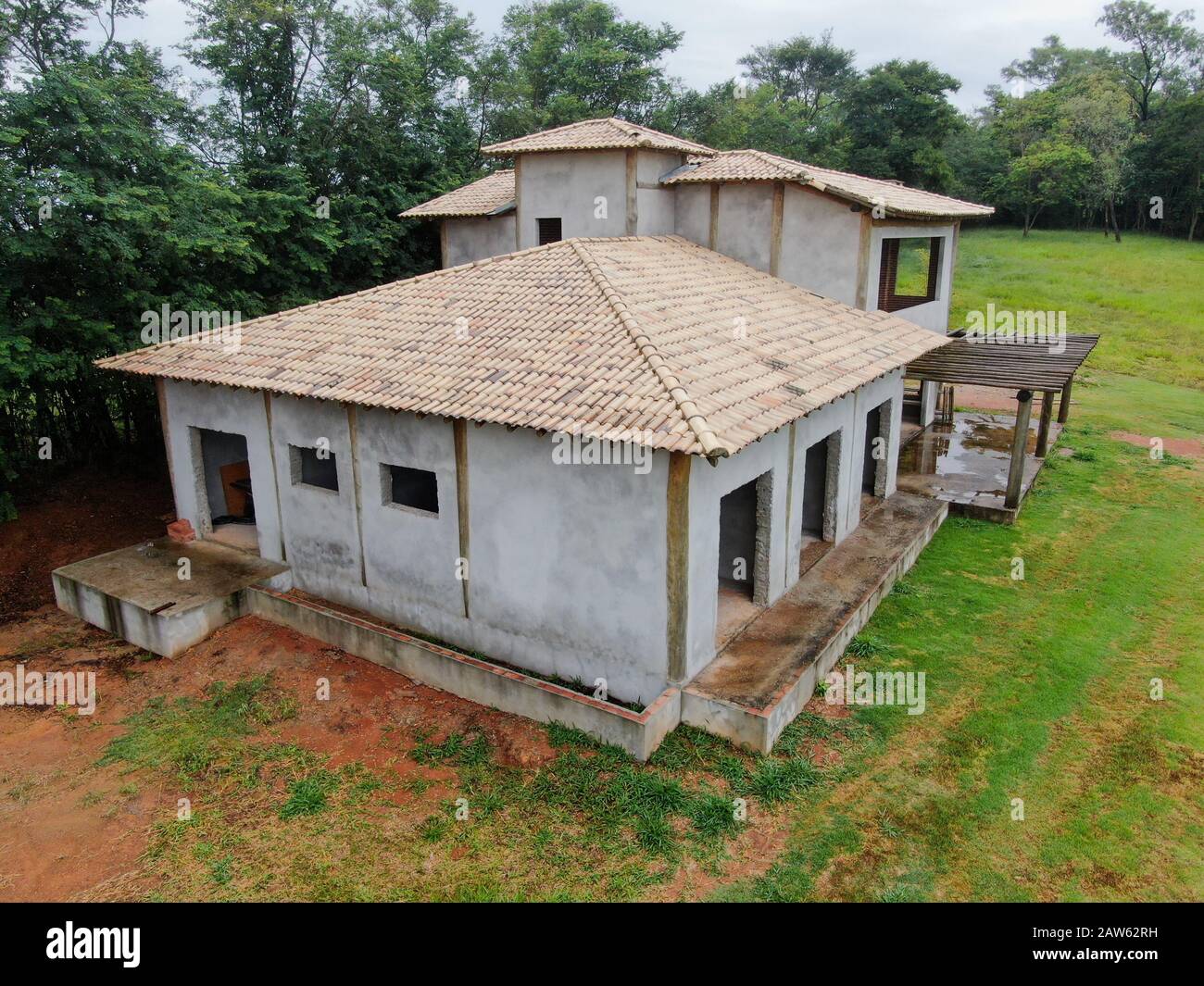Aerial view of home type villa under construction surrounded by green ...