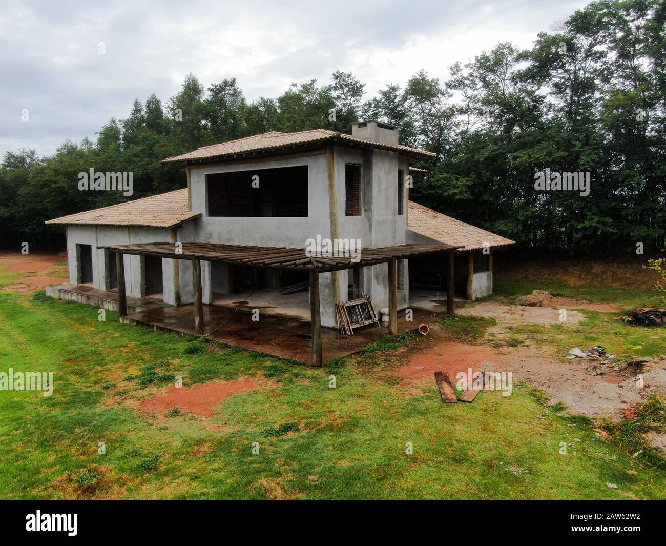 Aerial view of home type villa under construction surrounded by green ...