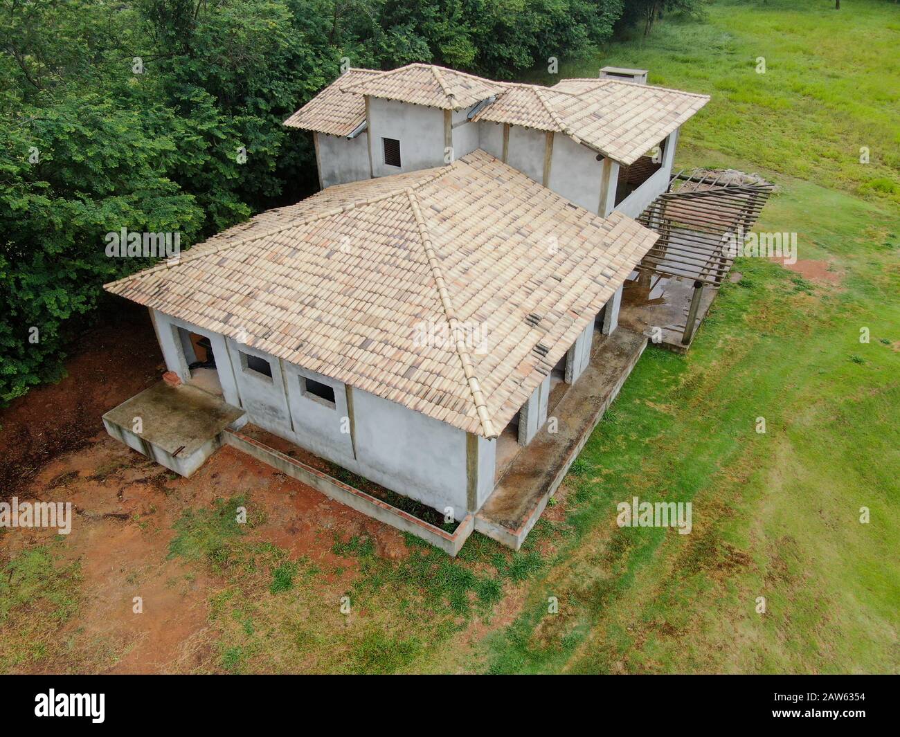 Aerial view of home type villa under construction surrounded by green ...