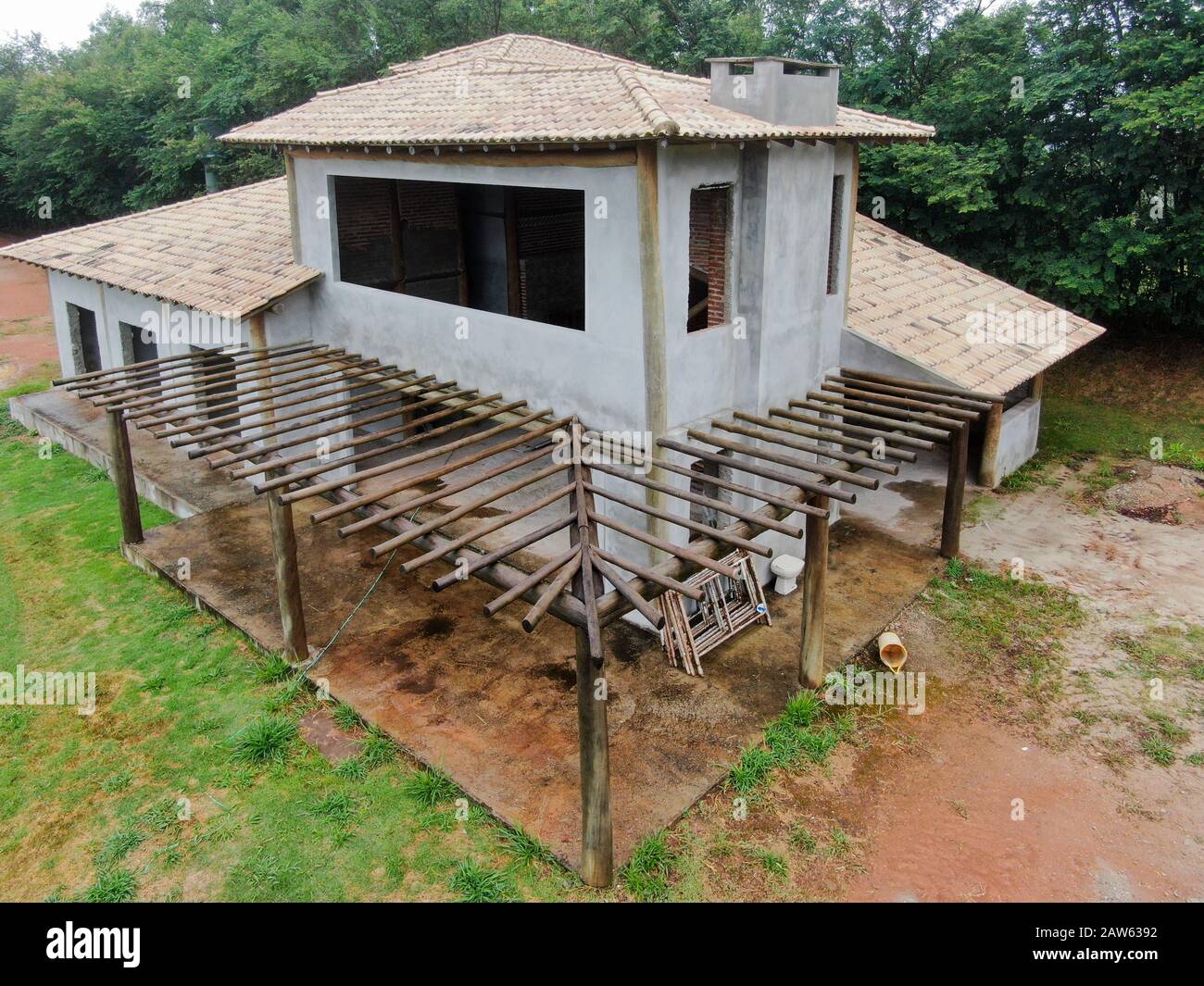 Aerial view of home type villa under construction surrounded by green ...