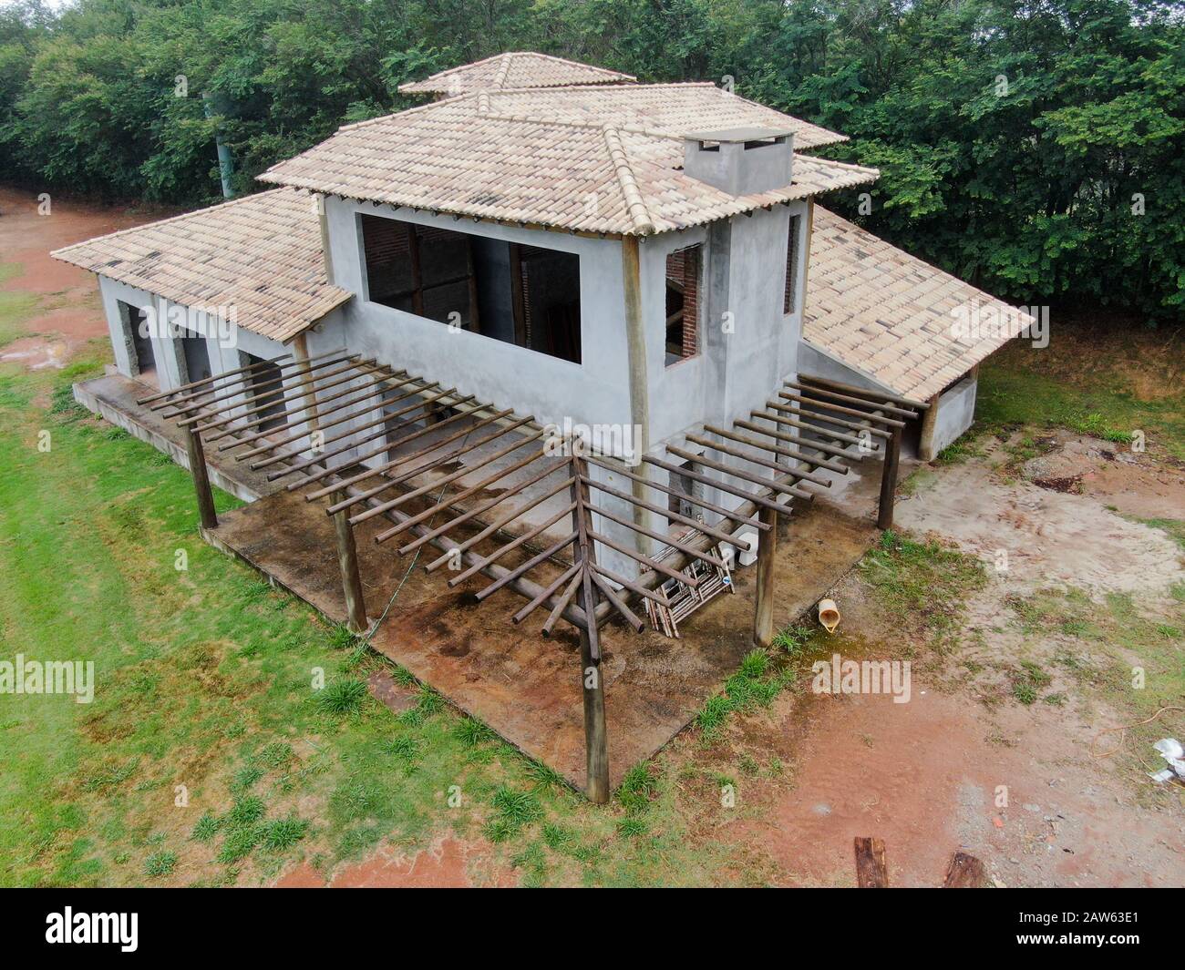Aerial view of home type villa under construction surrounded by green ...