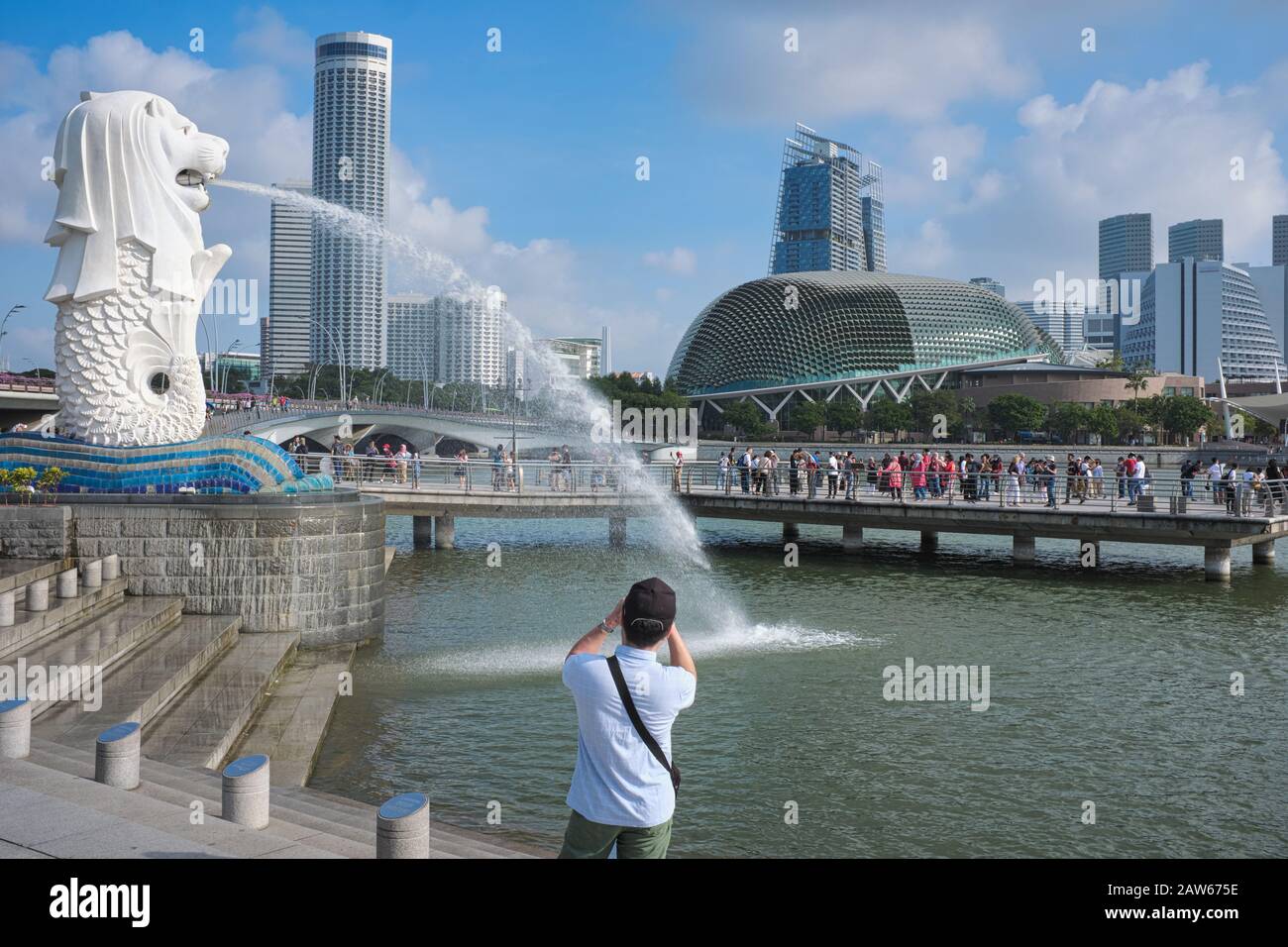 A tourist photographs the iconic Merlion at Merlion Park, Marina Bay ...