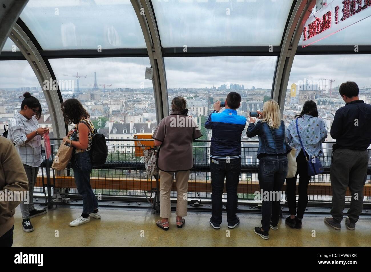Tourists photograph Paris from the rooftop level of the Centre Pompidou ...