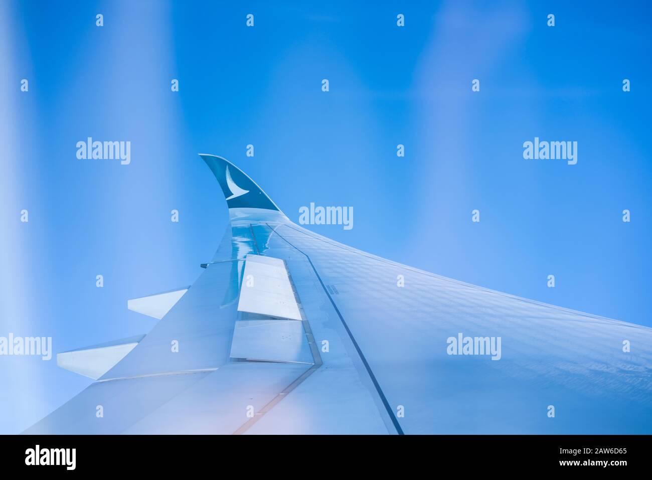 Singapore, April, 2019. The wing seen from the airplane window. Cathay ...