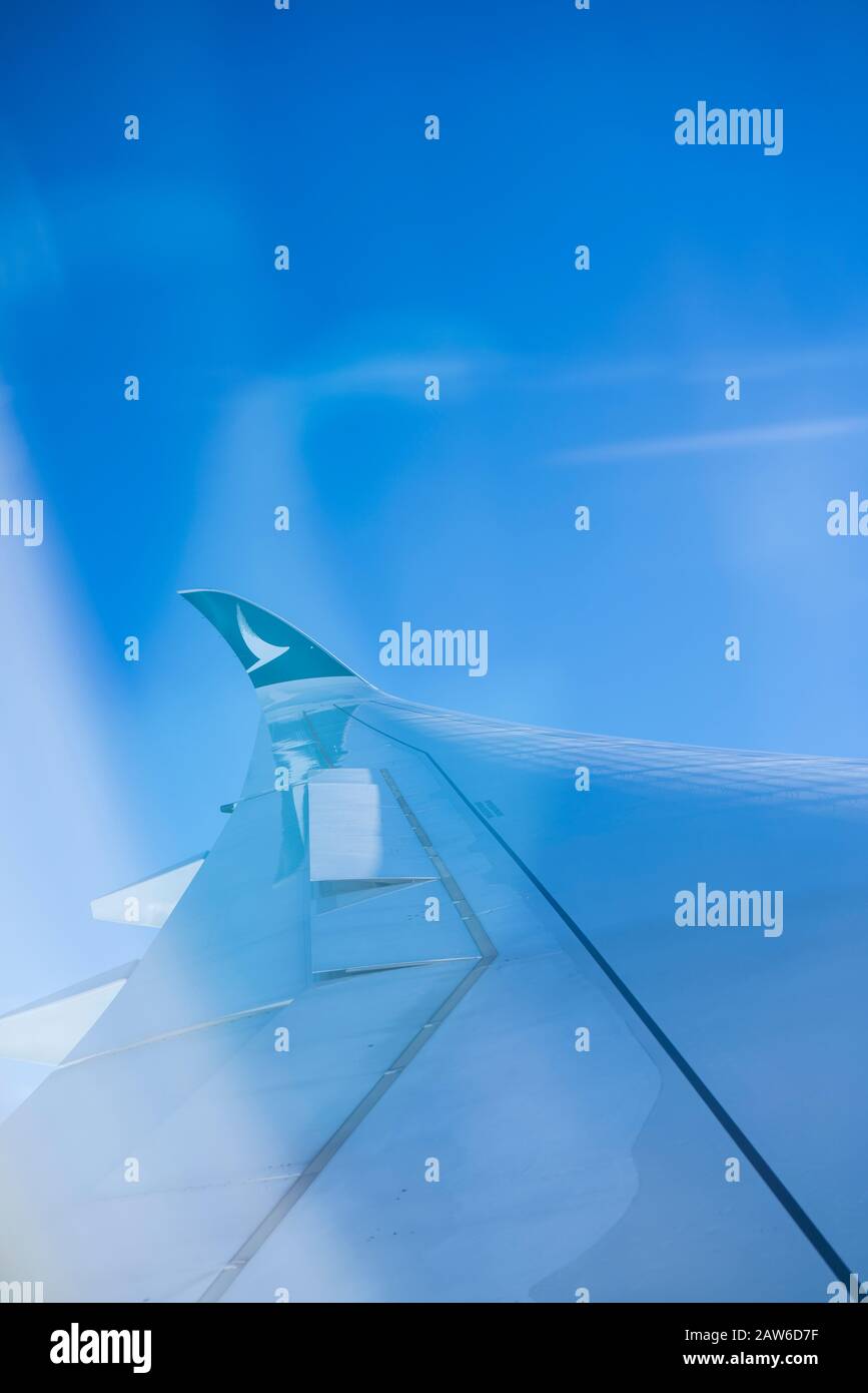 Singapore, April, 2019. The wing seen from the airplane window. Cathay ...