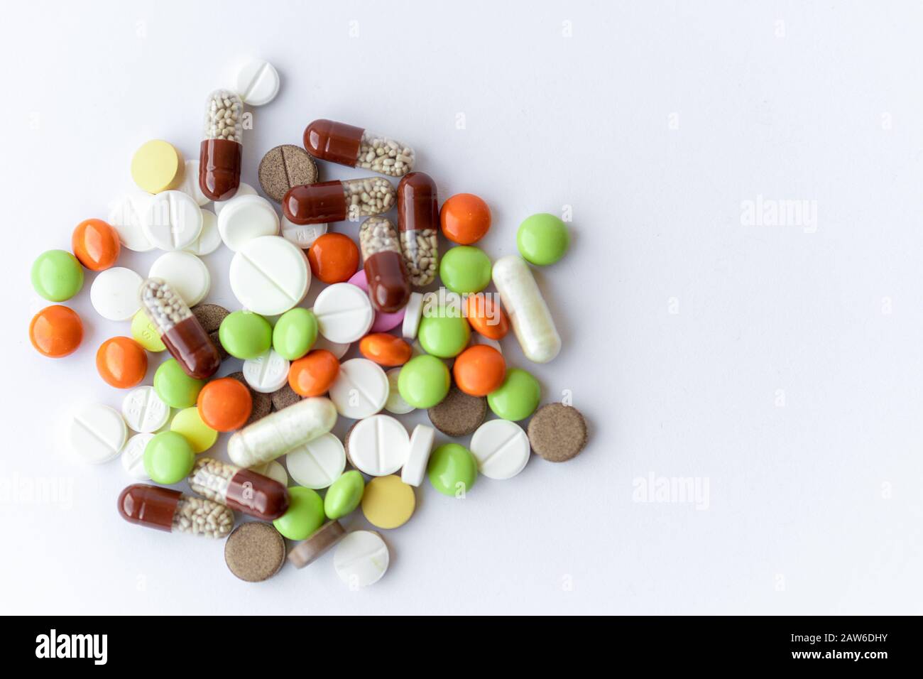 Medicines and pills. Multicolored medicines on a white background close ...