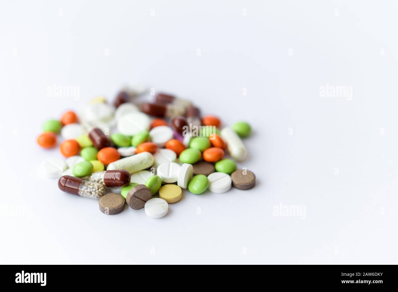 Medicines and pills. Multicolored medicines on a white background close ...