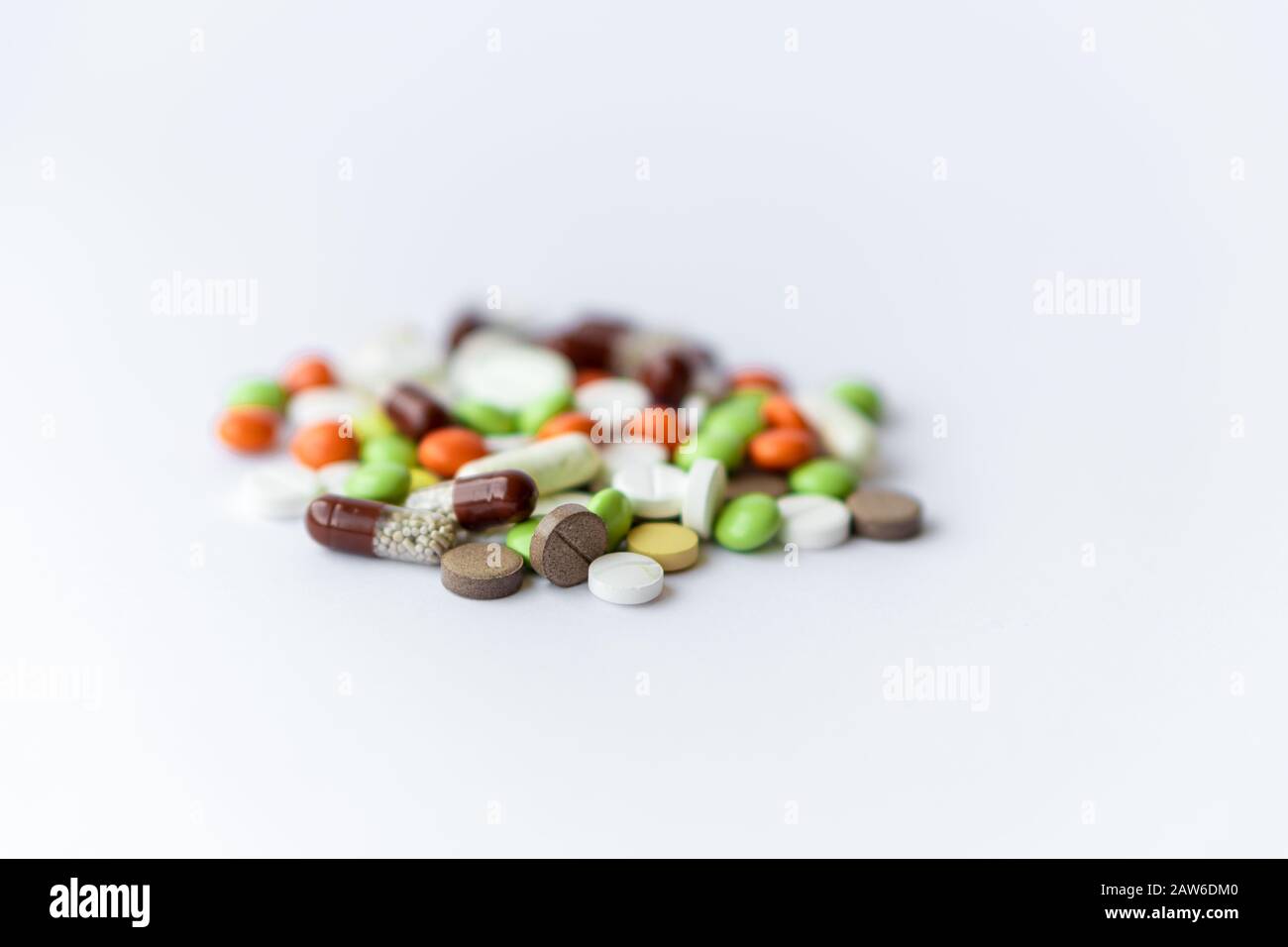 Medicines and pills. Multicolored medicines on a white background close ...