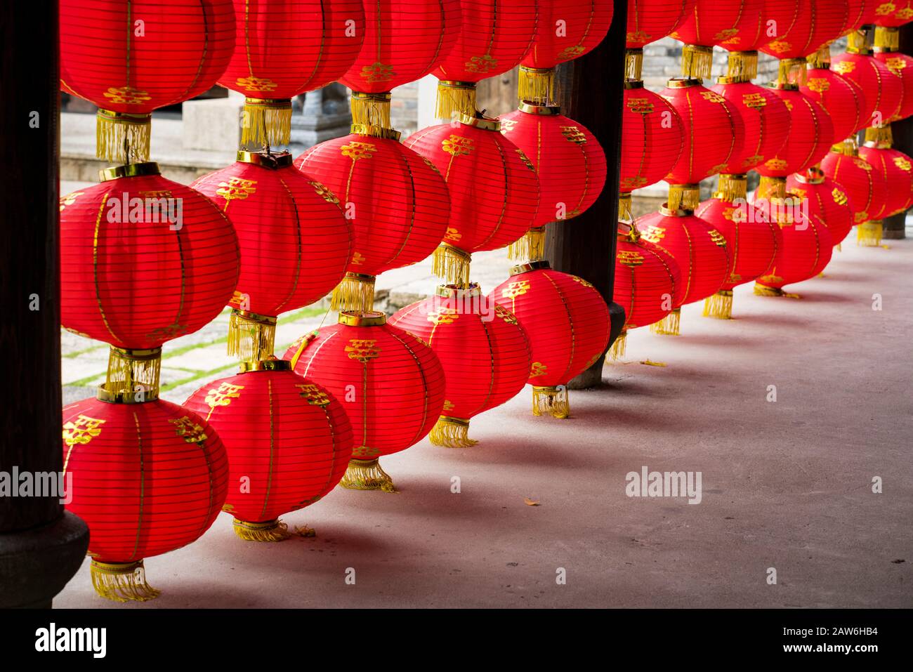 Red lanterns hanging on the old wooden building Stock Photo - Alamy