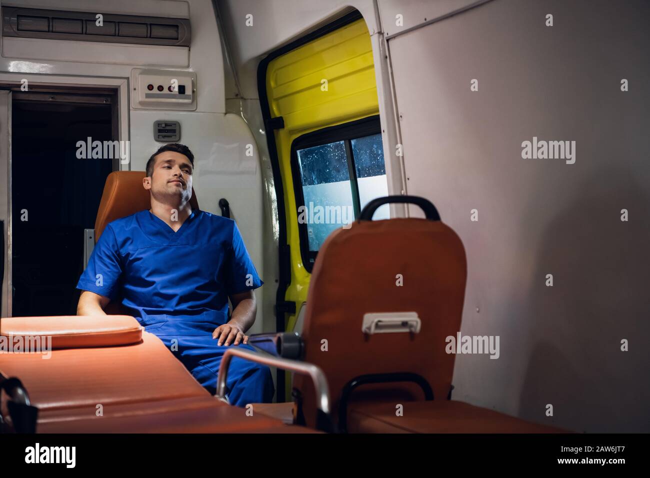 Corpsman in blue medical uniform sits in the ambulance car Stock Photo ...