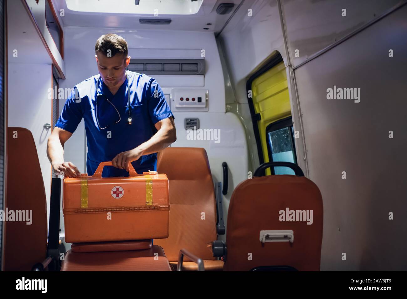 Corpsman in uniform closes medical bag in the ambulance car Stock Photo ...