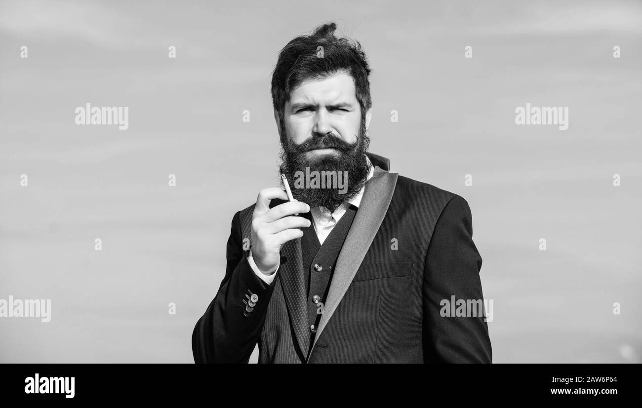 Smoking handsome. brutal caucasian hipster with moustache. Mature ...