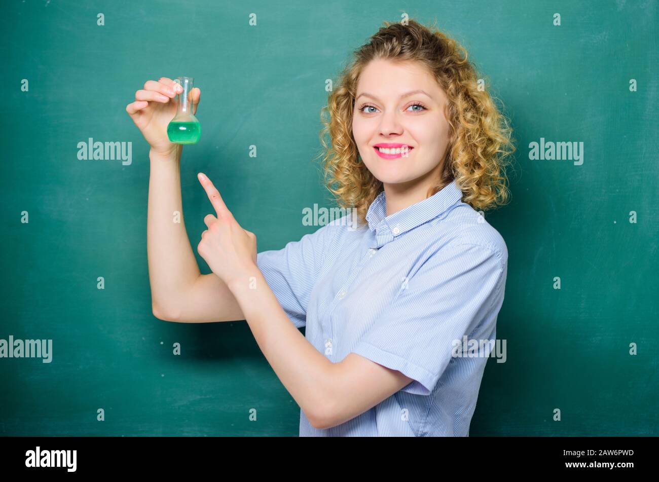 girl hold chemical flask with liquid. biology experiment. sample ...