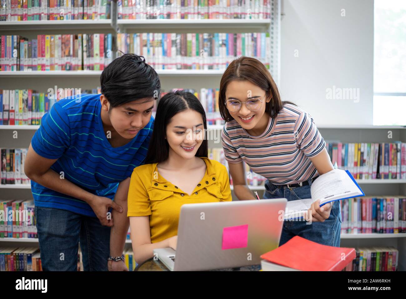 Group Asian Students Smile and reading book and using notebook for ...