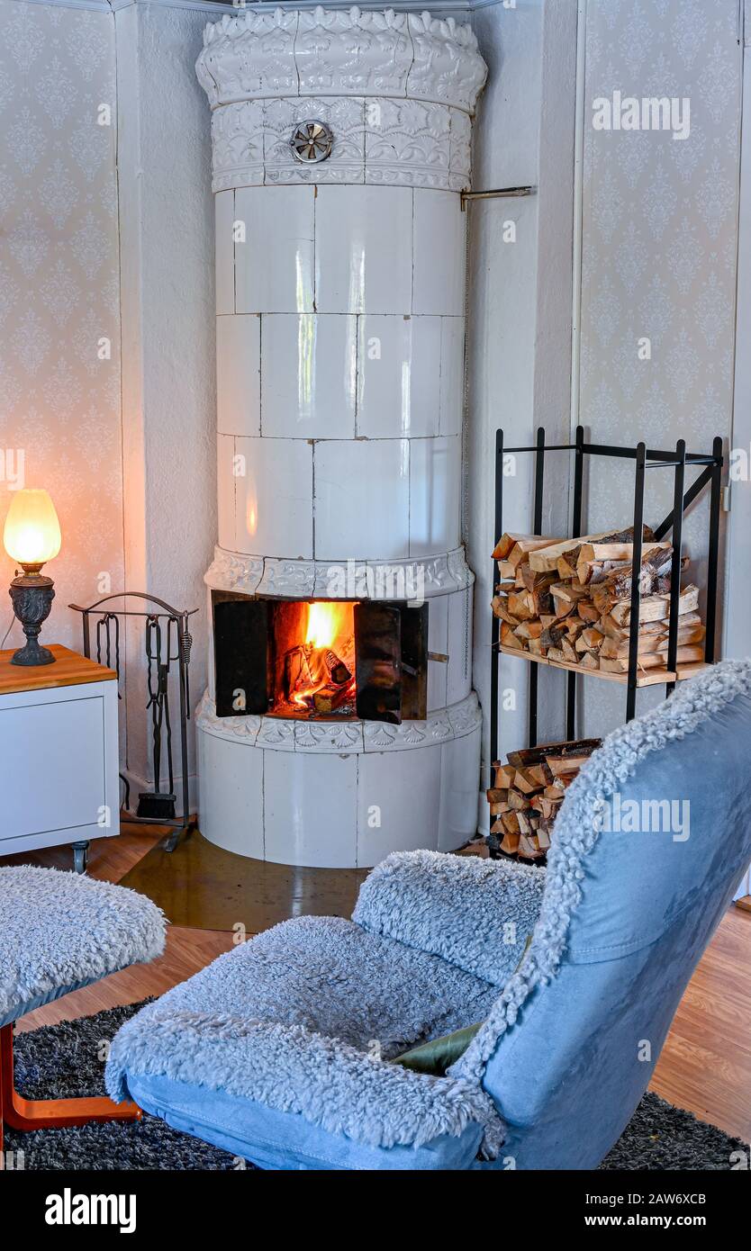 fire in a tiled stove in a cabin Stock Photo - Alamy
