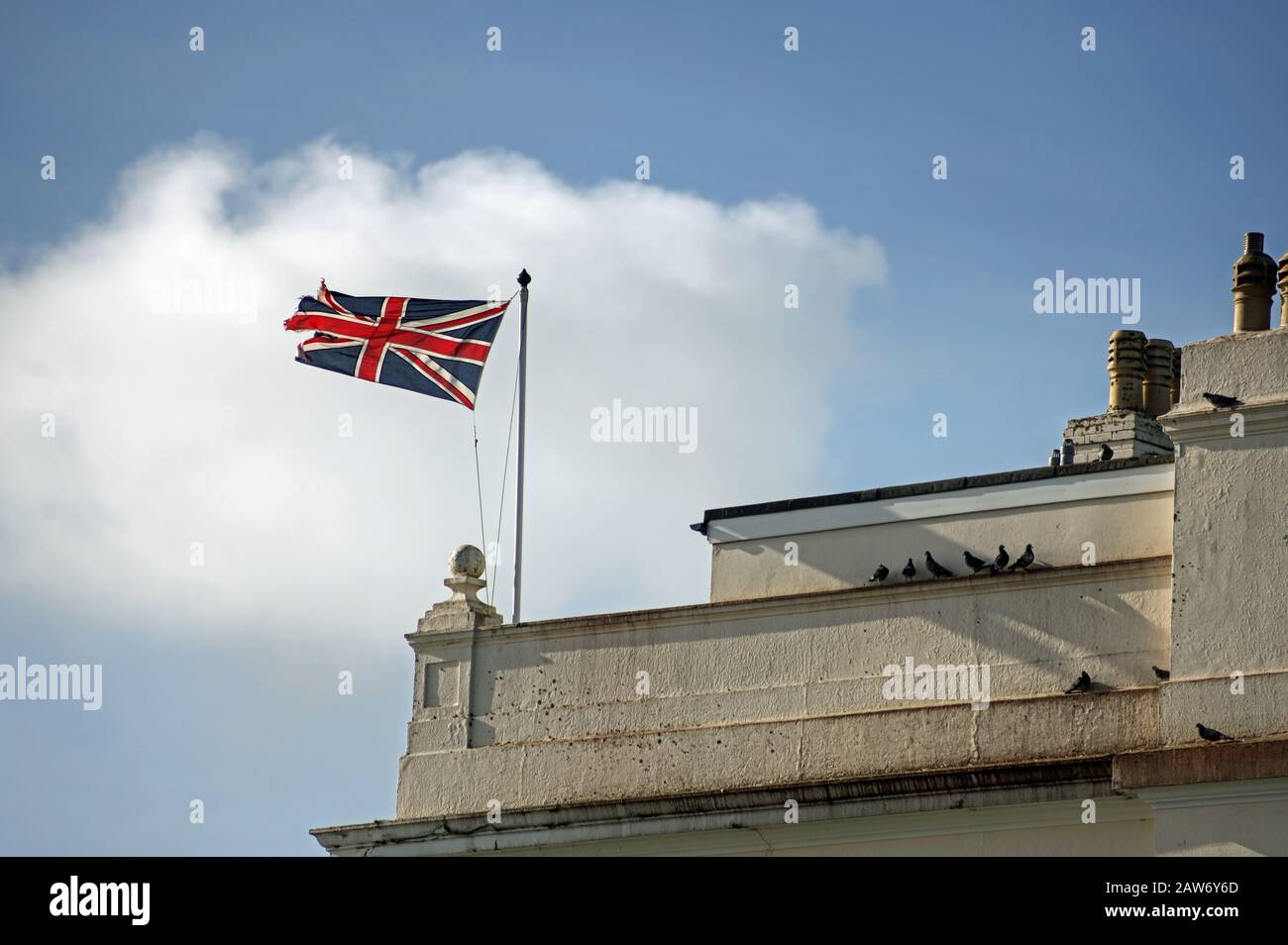 At the end of a terrace of seafront buildings in Plymouth, a tattered ...