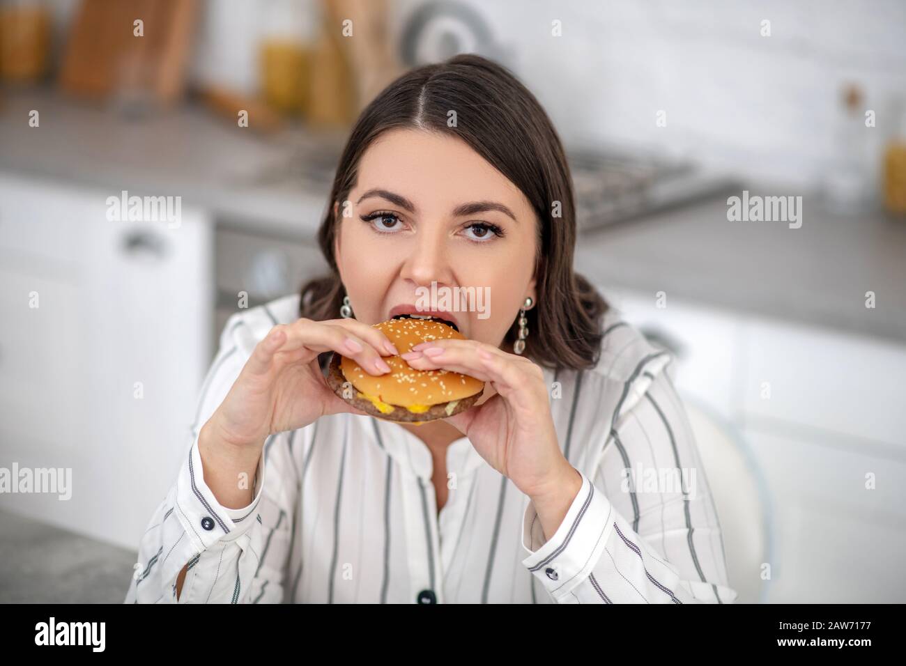 Woman alone biting chewing eating food hi-res stock photography and ...