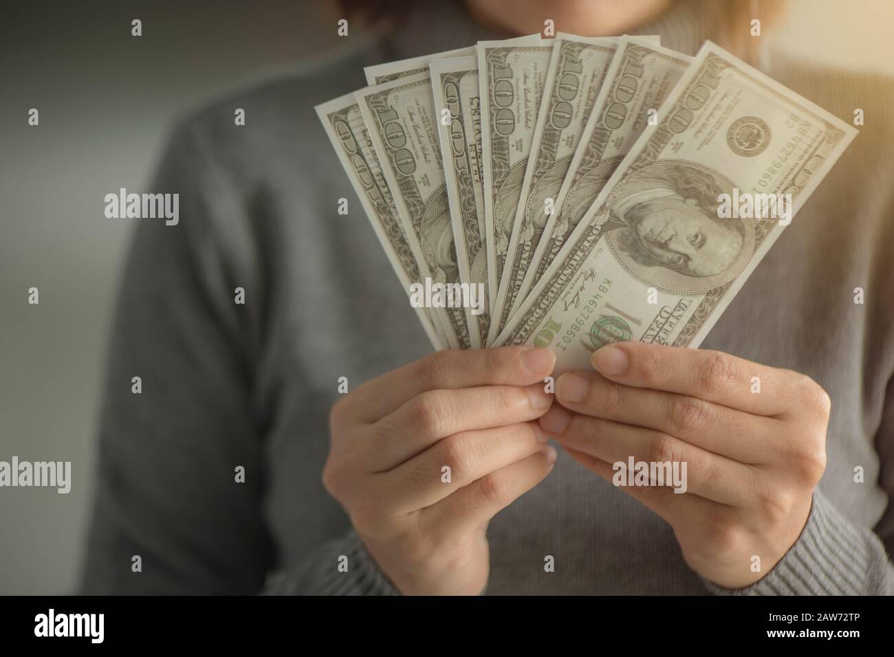 Woman holding money banknote hi-res stock photography and images - Alamy