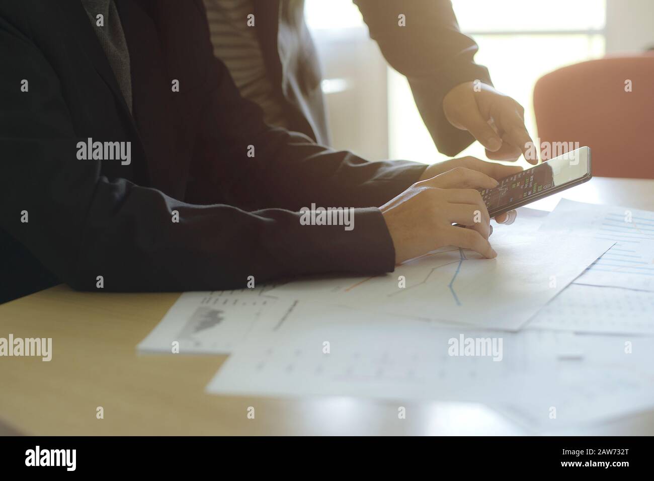 Business People hands are discussing with chart or graph documents at meeting. Teamwork ...