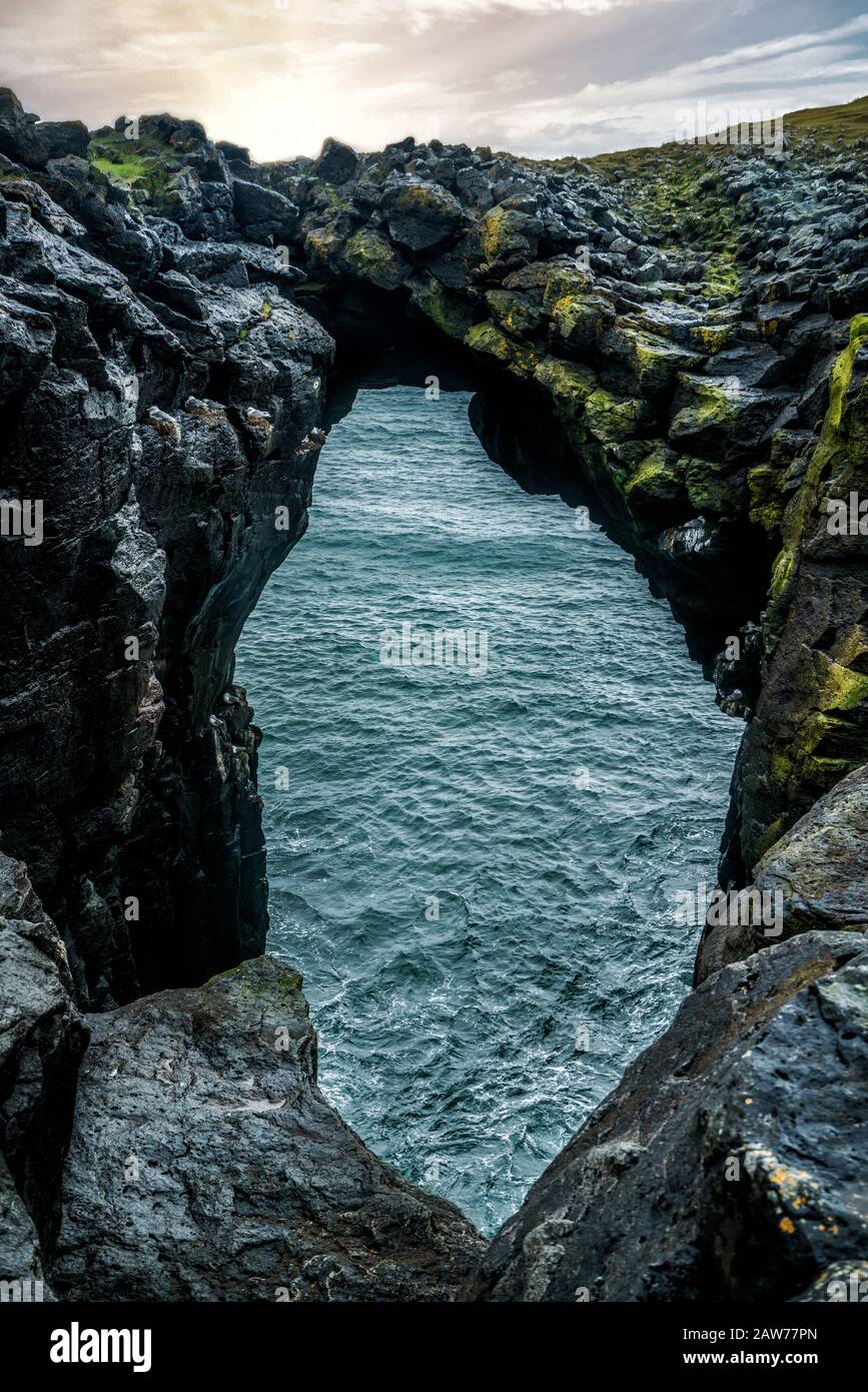 Rock bridge landscape in Arnarstapi, Iceland. Arnarstapi was an ...