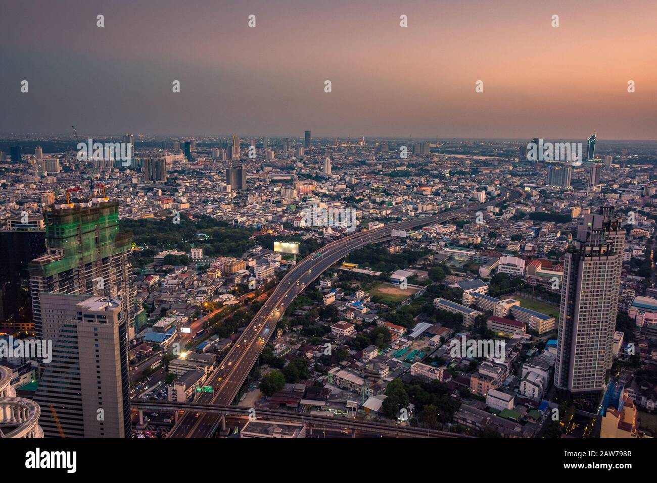 Aerial view of Bangkok capital city at sunset. Birds eye view of urban sprawl, modern Asian ...
