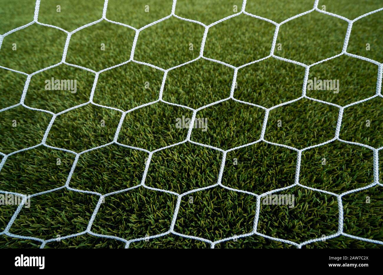 Soccer football net background over green grass Stock Photo - Alamy