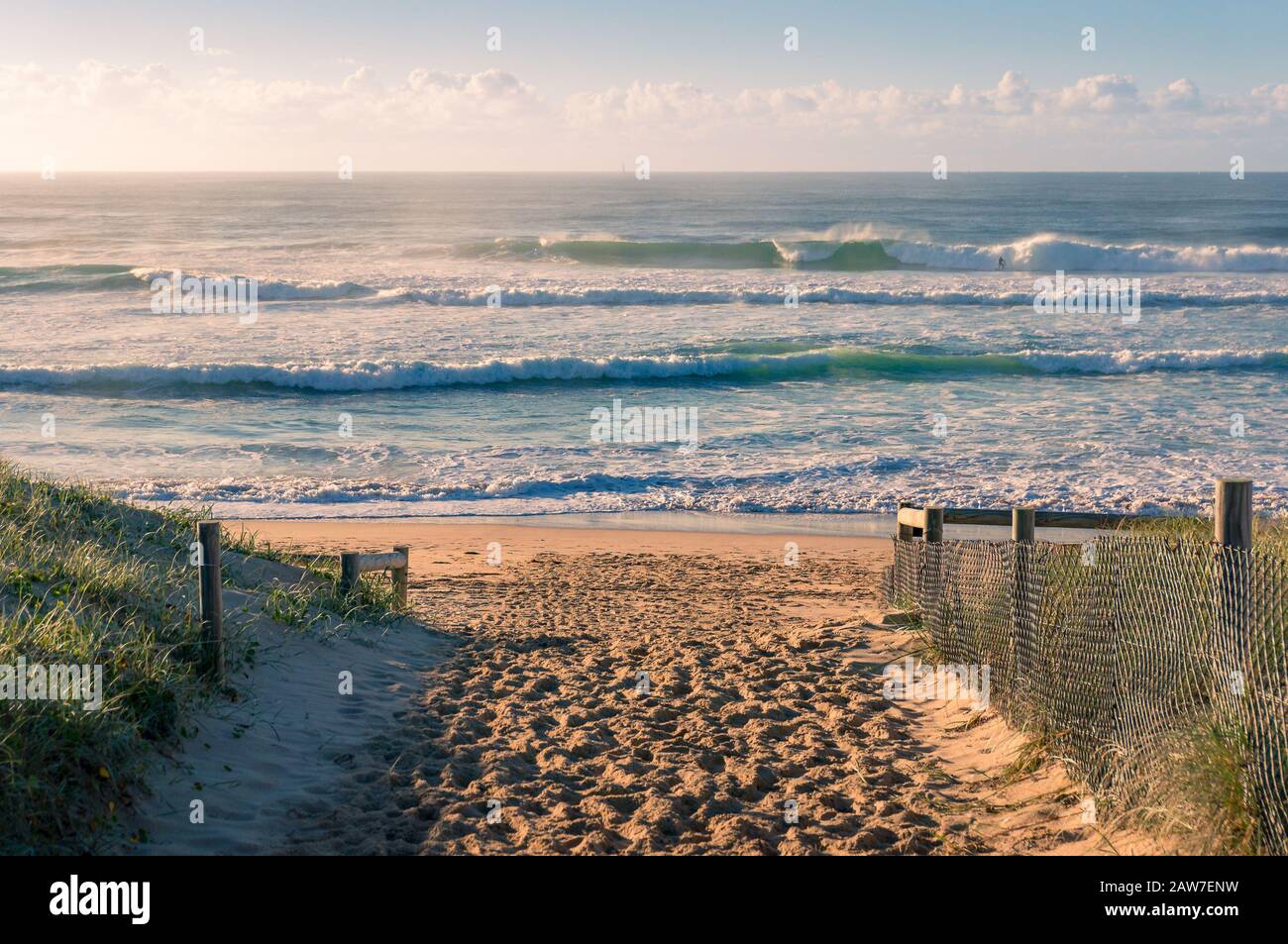 Entrance to the beach with beautiful waves at sunrise with soft ...