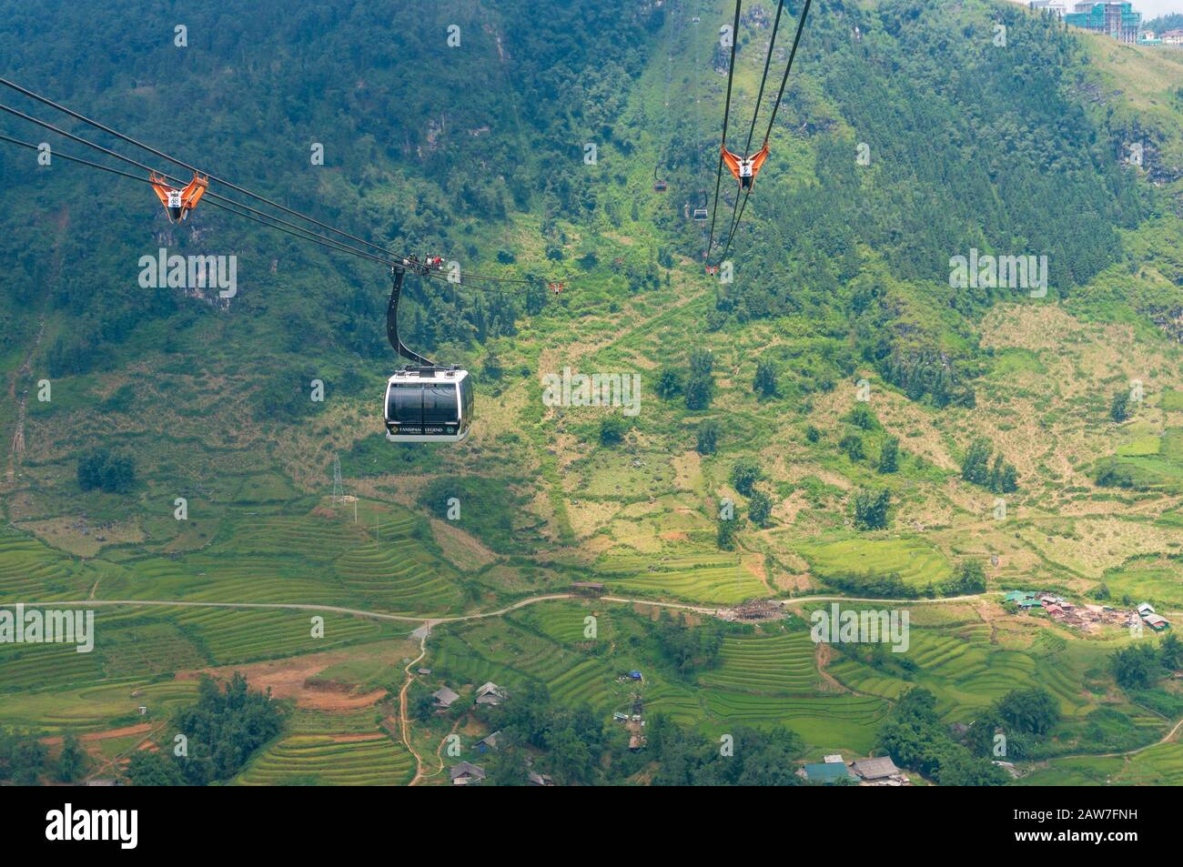 Sapa, Vietnam - August 20, 2017: Cable car riding over green mountain ...