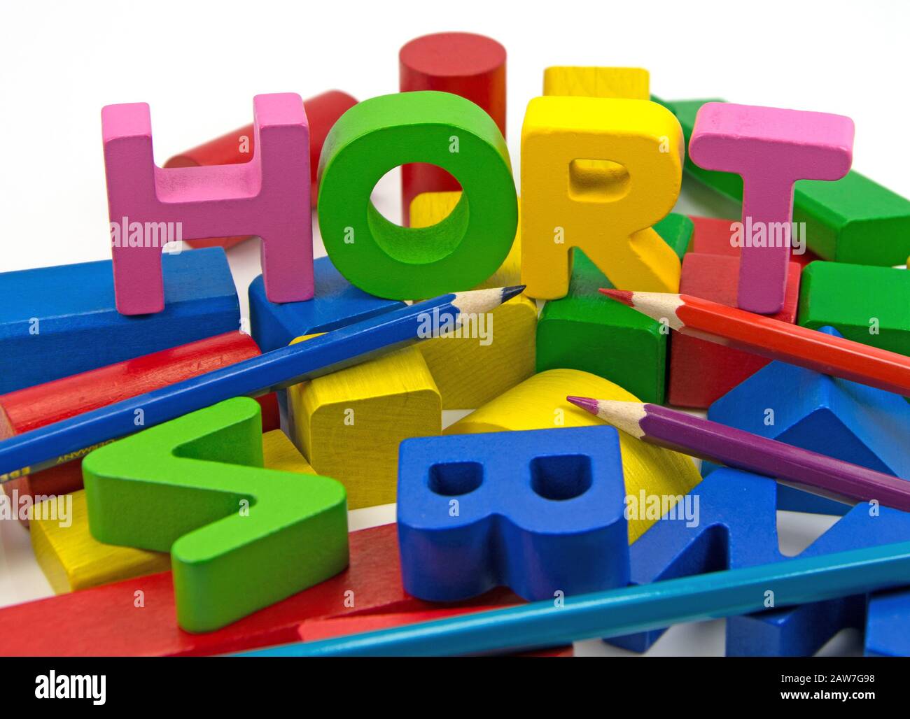 Colorful wooden letters, wood building bricks and colored pencils ...