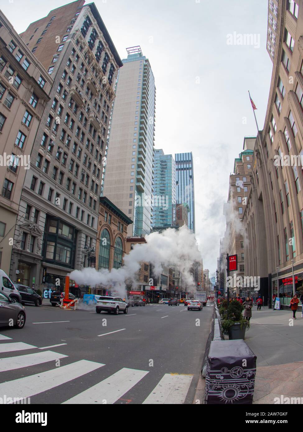 New York City street road in Manhattan. Buildings, steam and ...