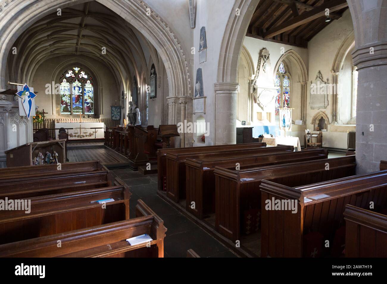 View past wooden pews through chancel arch to sanctuary and altar ...