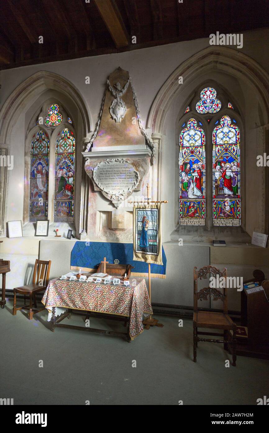 Side chapel altar, stained glass windows inside the church at Urchfont ...