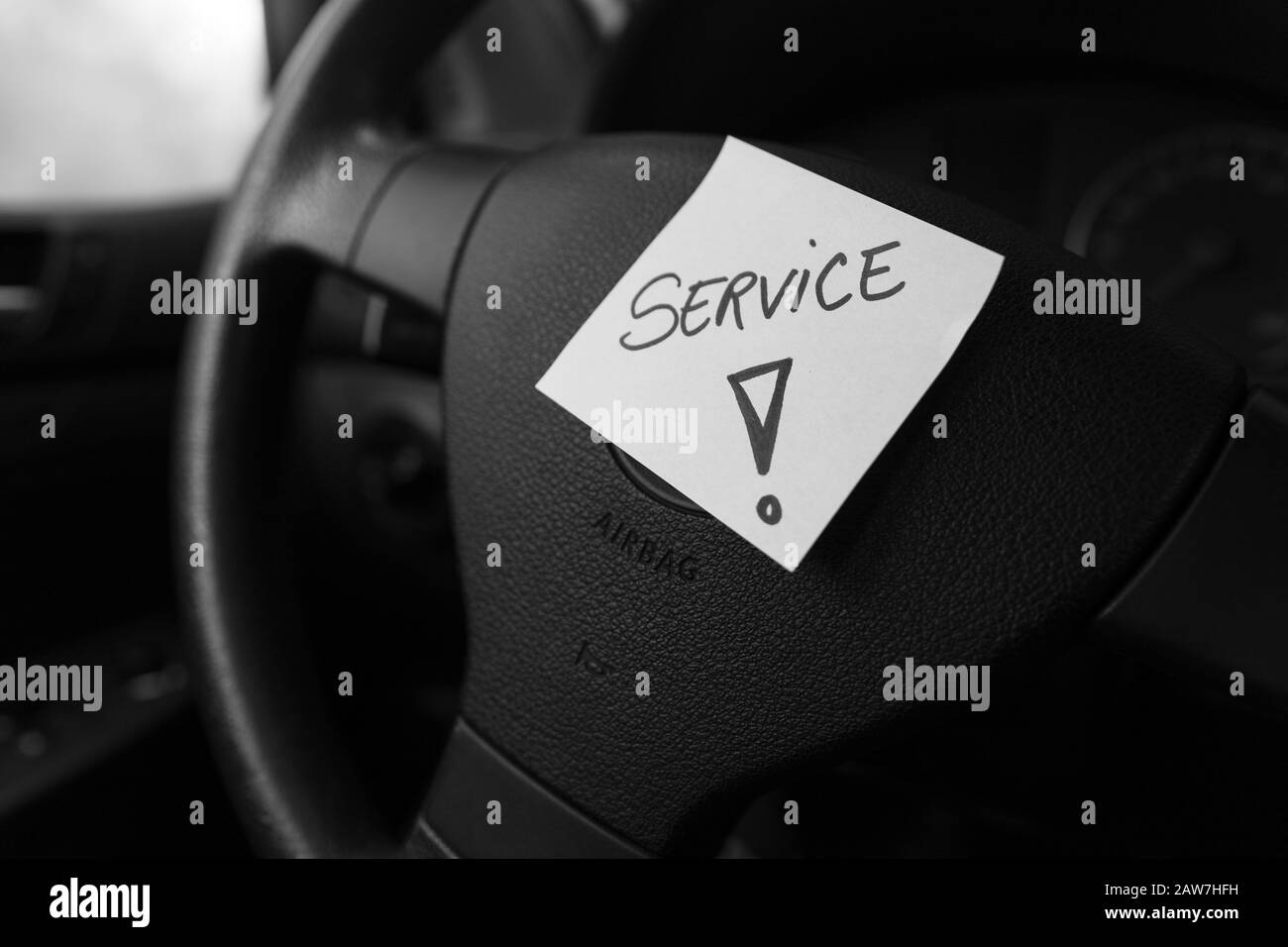 Writing service on memo post reminder. Text on sticky paper inside car ...