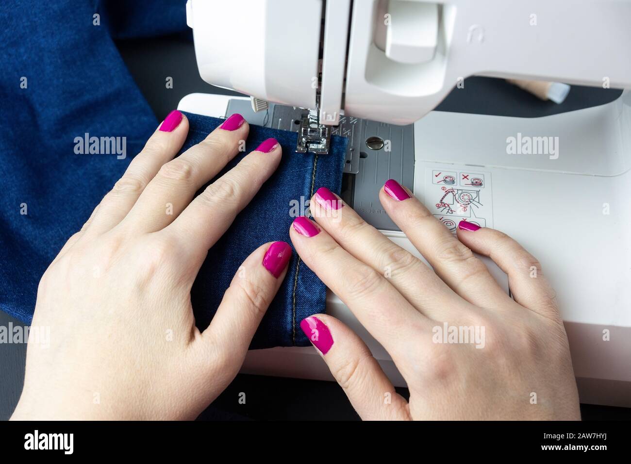 the process of tailoring, woman's hands with a cloth on the sewing ...