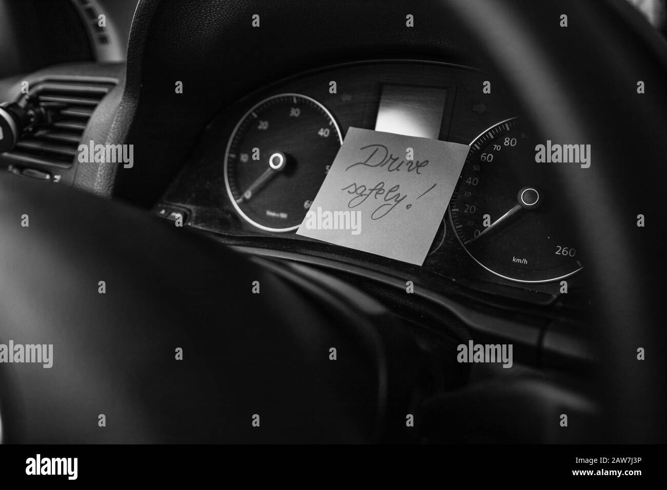 Writing drive safely on memo post reminder. Text on sticky paper inside ...